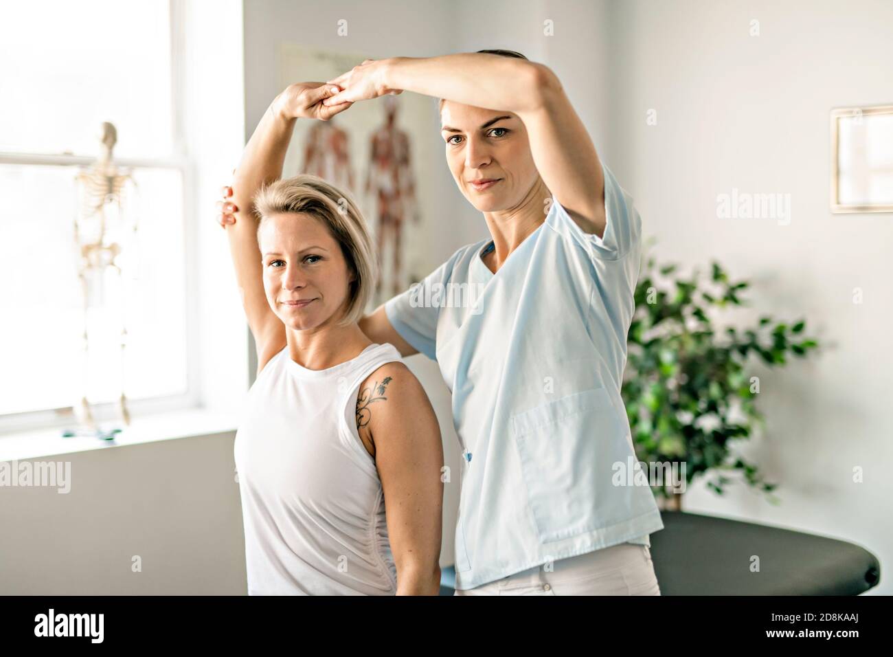 A Modern rehabilitation physiotherapy worker with woman client Stock ...