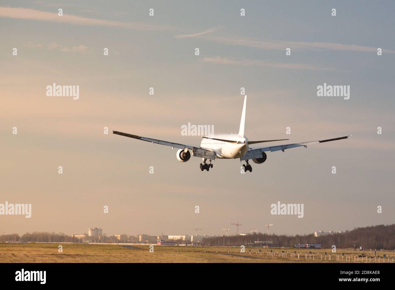 Airplane landing at airport in sunny day, back view. Silhouette of ...