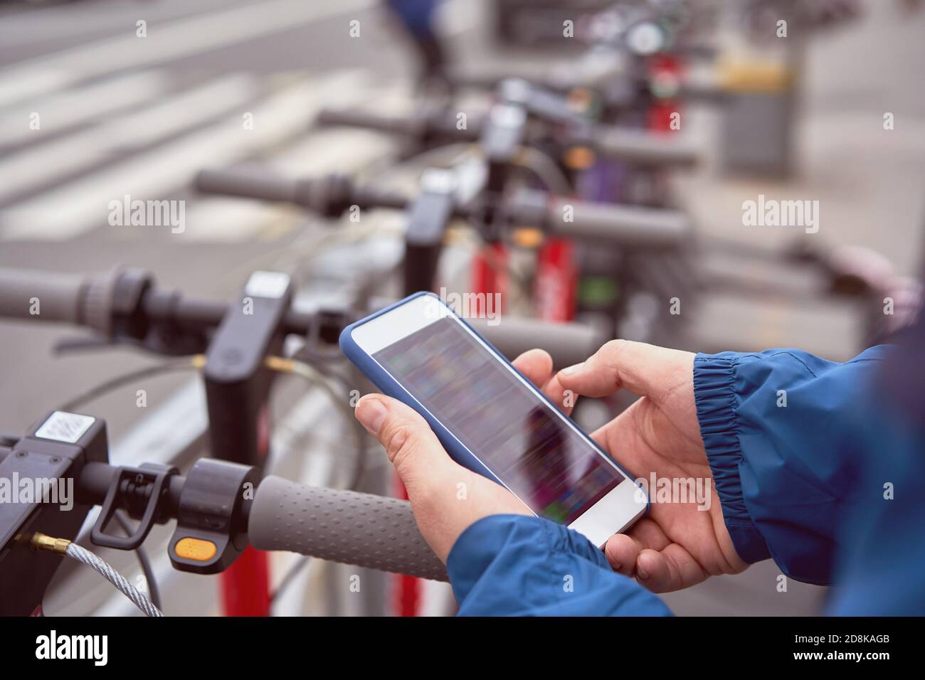 Man is scanning QR code to rent electric scooter on open air Stock ...