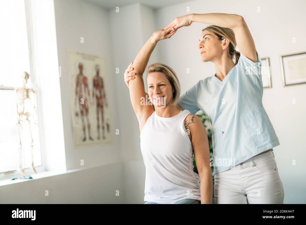 A Modern rehabilitation physiotherapy worker with woman client Stock ...