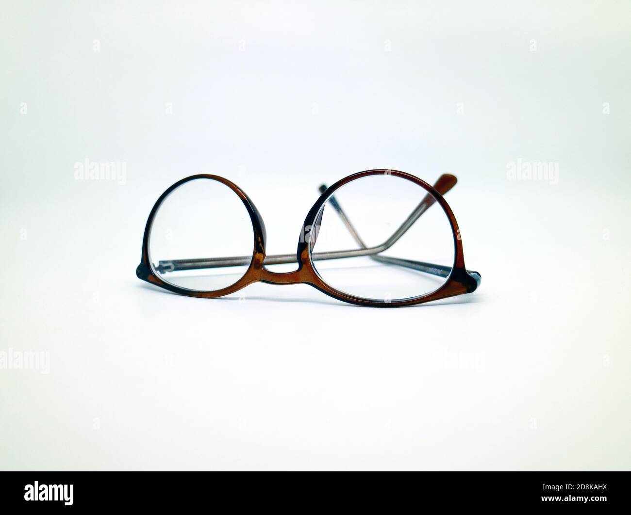 Brown glasses on white background Stock Photo - Alamy