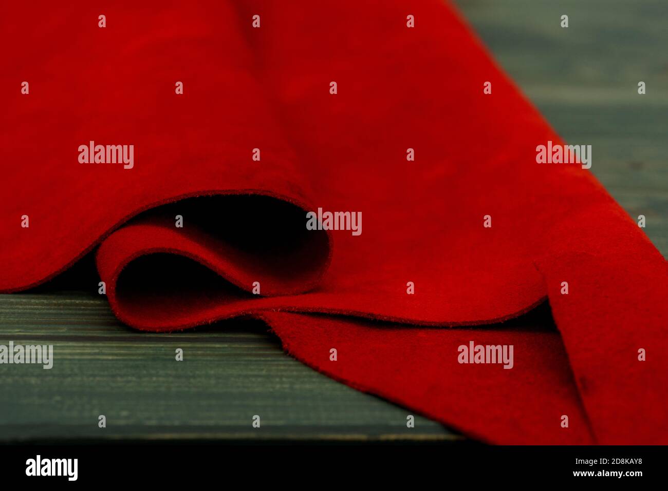 Red matte background of suede fabric, closeup. Velvet texture of ...