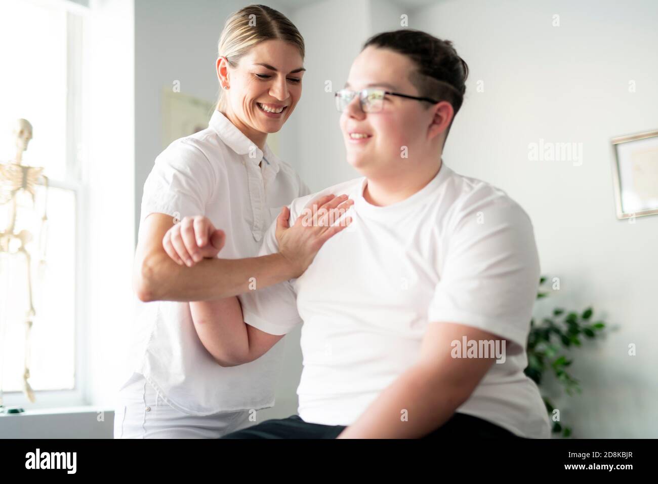 A Modern rehabilitation physiotherapy woman worker with client Stock ...