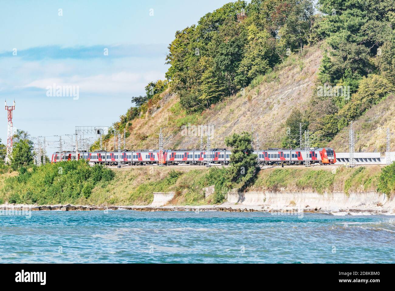 Passenger train moves along Black sea coast. Sochi. Russia Stock Photo ...