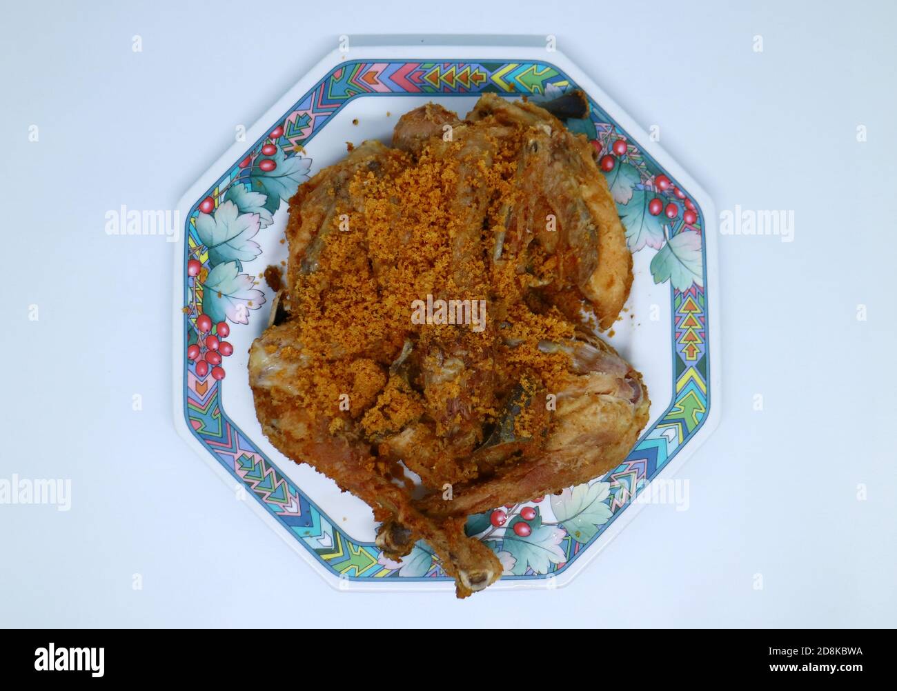 Fried chicken with crispy spiced flakes on white background. Indonesian ...