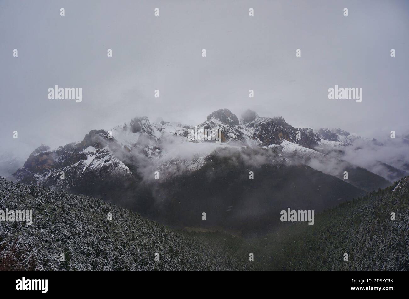 Majestic snowy mountain range during snowfall Stock Photo - Alamy