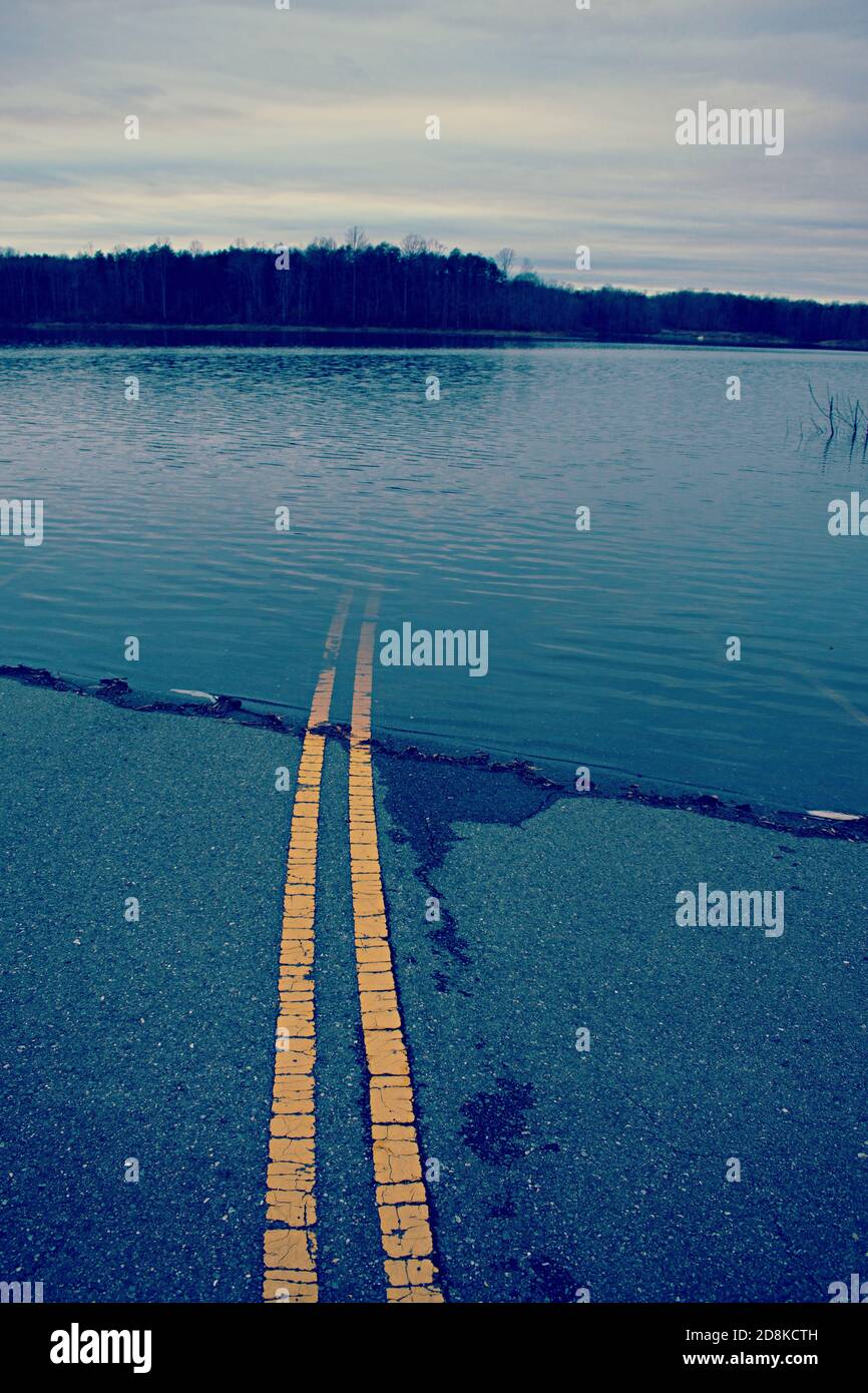 The paved road going into the water from creating a man made dam lake ...