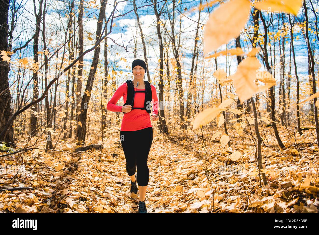 A running woman jogging in autumn nature Stock Photo - Alamy