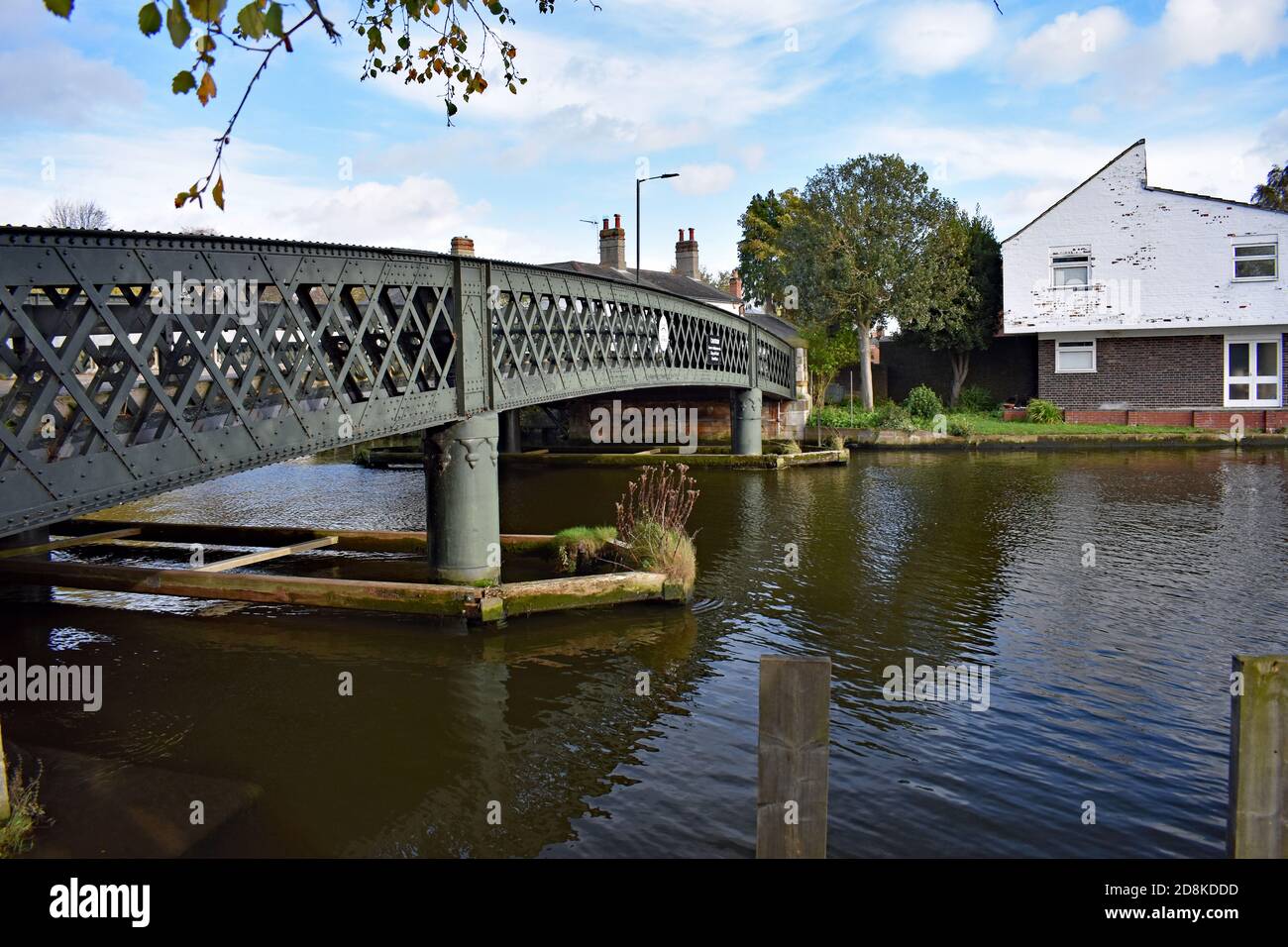 A painted green metal bridge cross the River Waveney in the town of ...