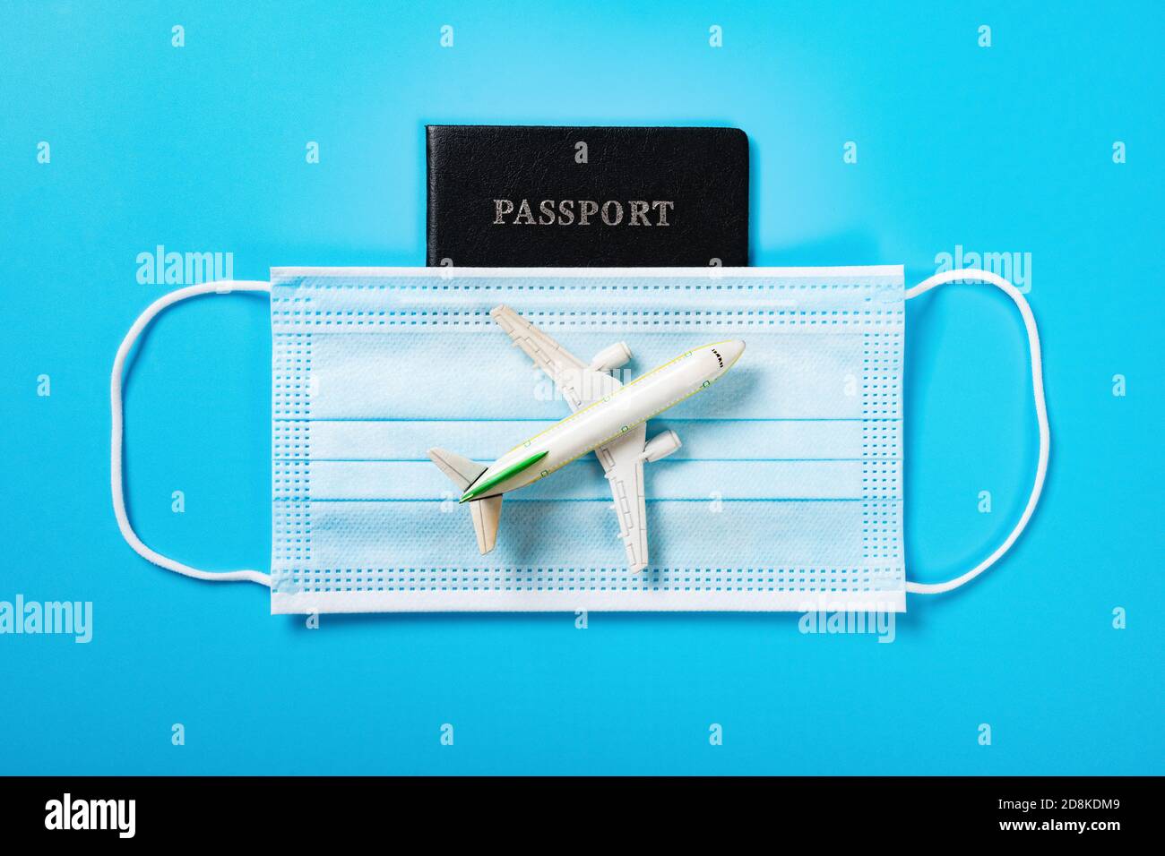 airplane model above a medical mask and a passport Stock Photo - Alamy