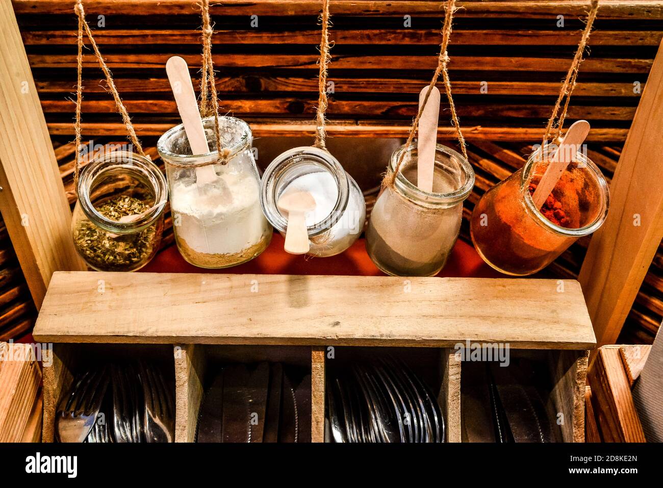 Hanging bottles of condiments at a cafe Stock Photo - Alamy