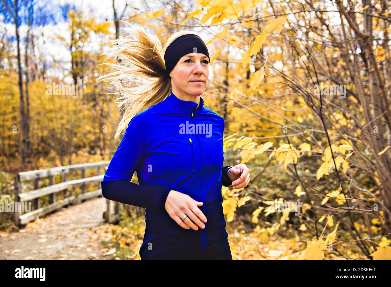 A running woman jogging in autumn nature Stock Photo - Alamy