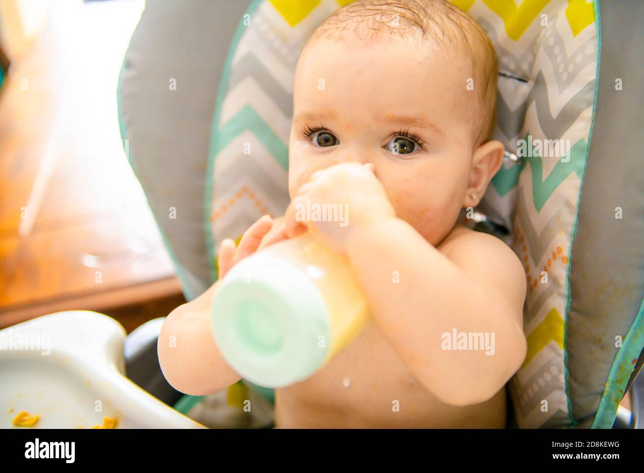 A Little baby drinking milk and making a mess Stock Photo - Alamy