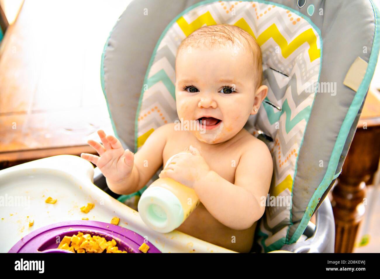 A Little baby drinking milk and making a mess Stock Photo - Alamy