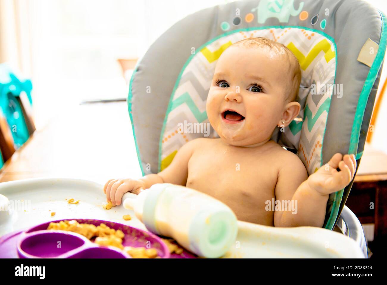 A Little baby drinking milk and making a mess Stock Photo - Alamy