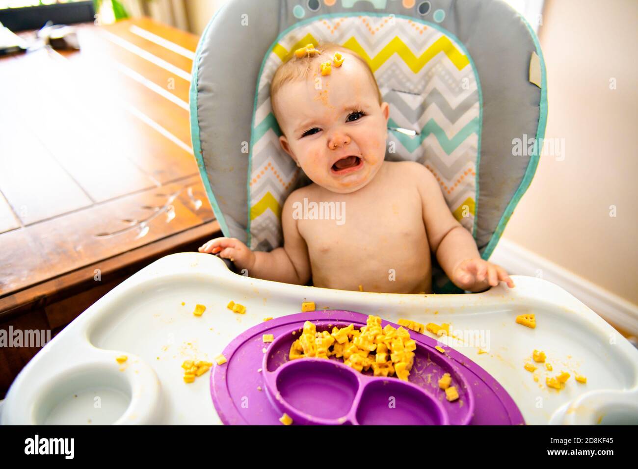 Little baby eating her dinner and making a mess Stock Photo - Alamy