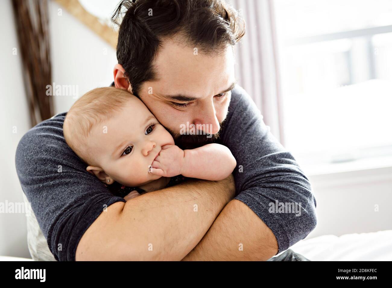 A Nice and protect father with baby on bed Stock Photo - Alamy