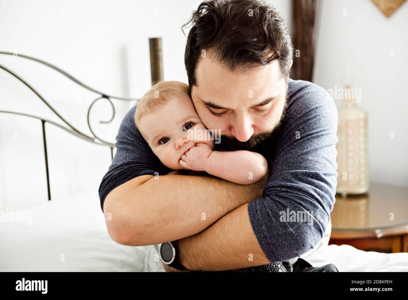 A Nice and protect father with baby on bed Stock Photo - Alamy
