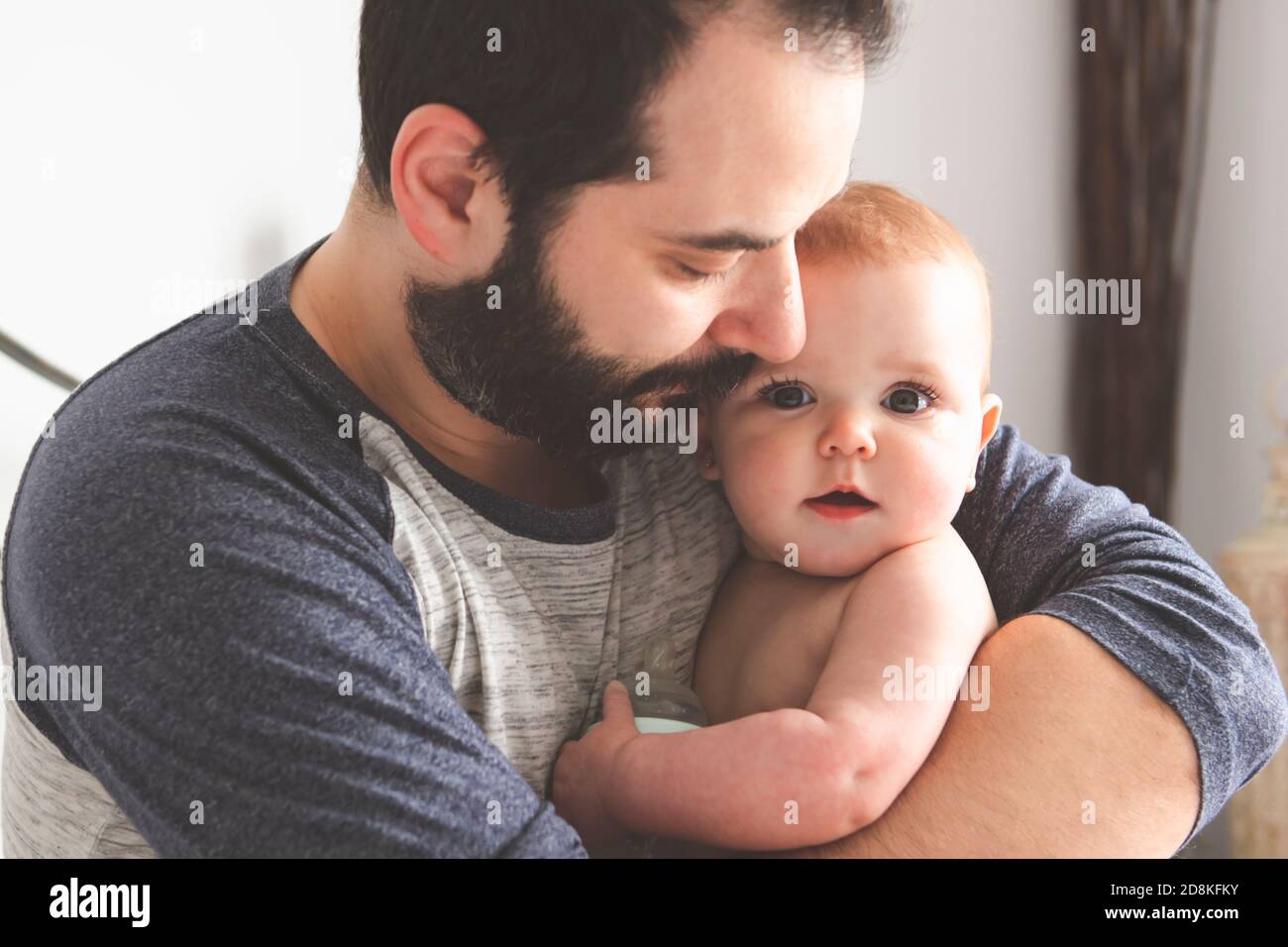 A Nice and protect father with baby on bed Stock Photo - Alamy