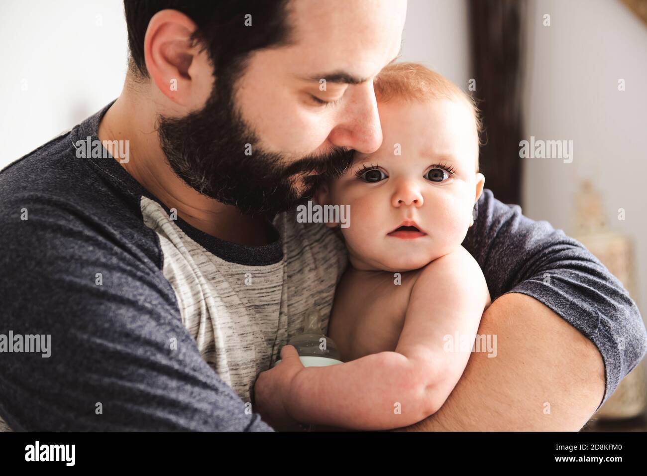A Nice and protect father with baby on bed Stock Photo - Alamy