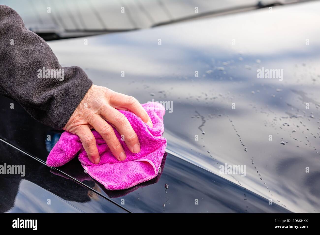 Closeup of a male hand washing a car with a pink rag Stock Photo - Alamy