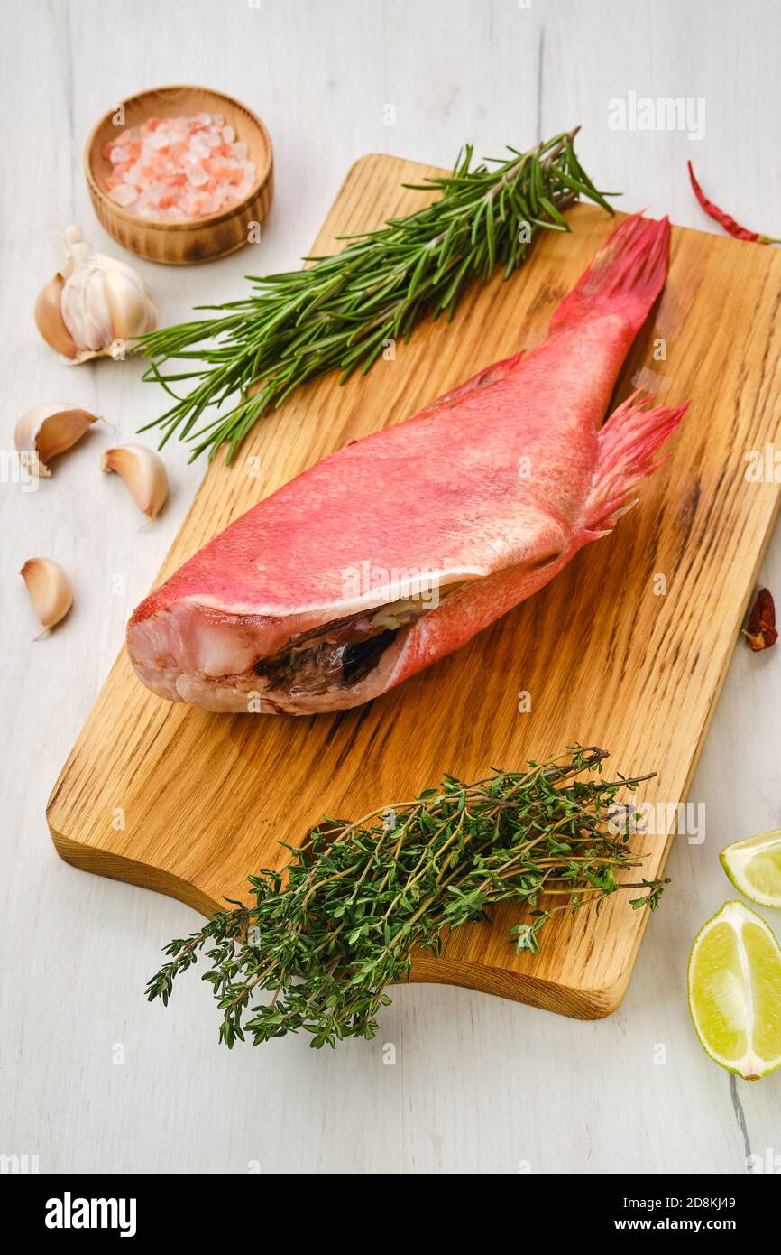 Fresh frozen headless ocean perch with spice and herbs Stock Photo - Alamy