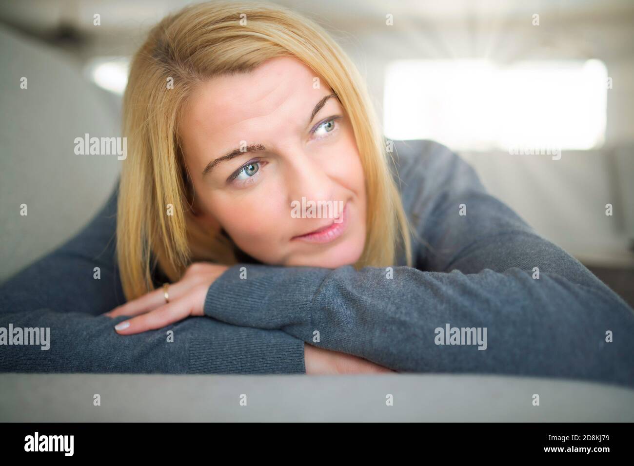 Relaxed woman enjoying rest on comfortable sofa, calm attractive girl ...
