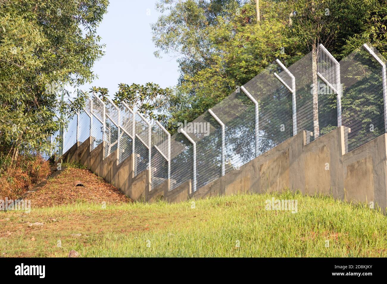 Tall security fence define boundary prevent intrusion into private ...