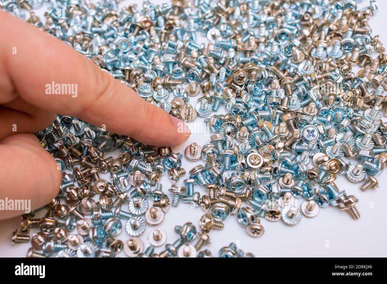 The worker selects screws from a large set for his job Stock Photo - Alamy