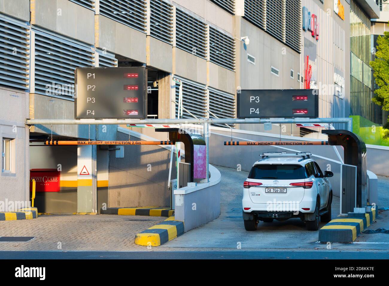 4x4 vehicle waits to drive up a ramp into a public car park in a ...