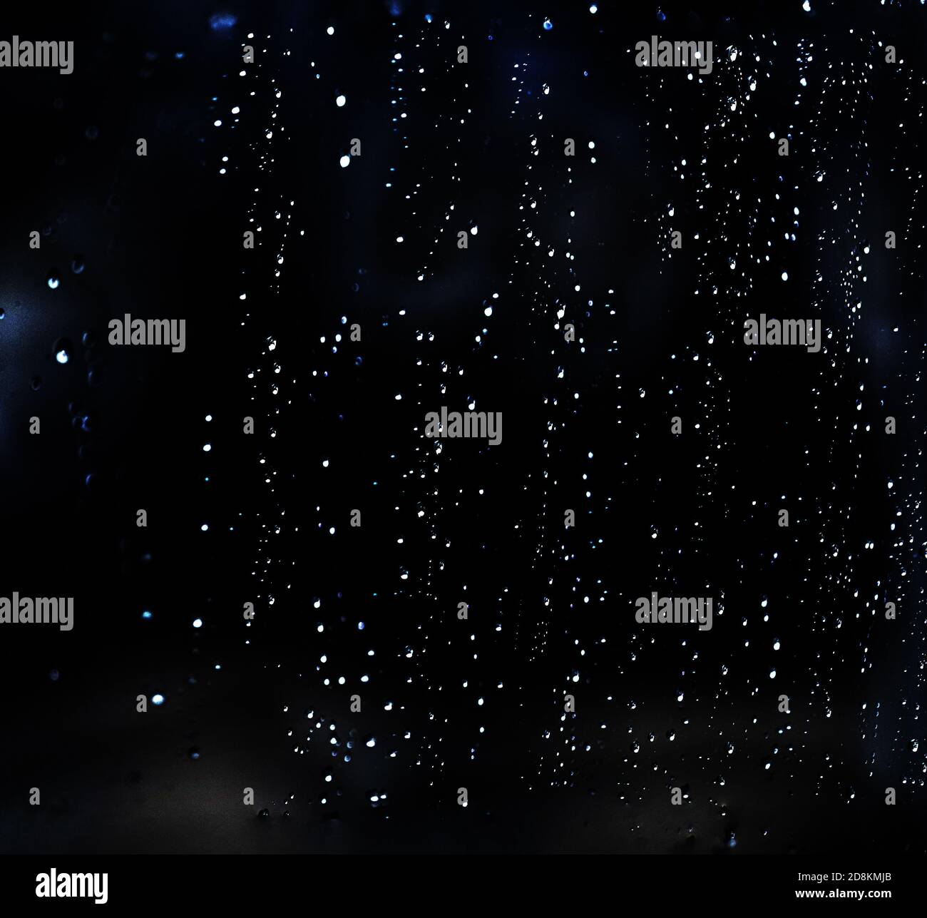 Rain water drops on a black dramatic window glass. Autumn depression ...