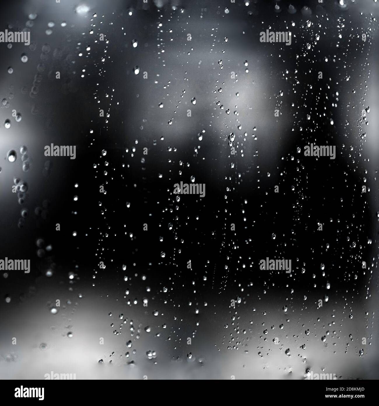 Rain water drops on a black dramatic window glass. Autumn depression ...
