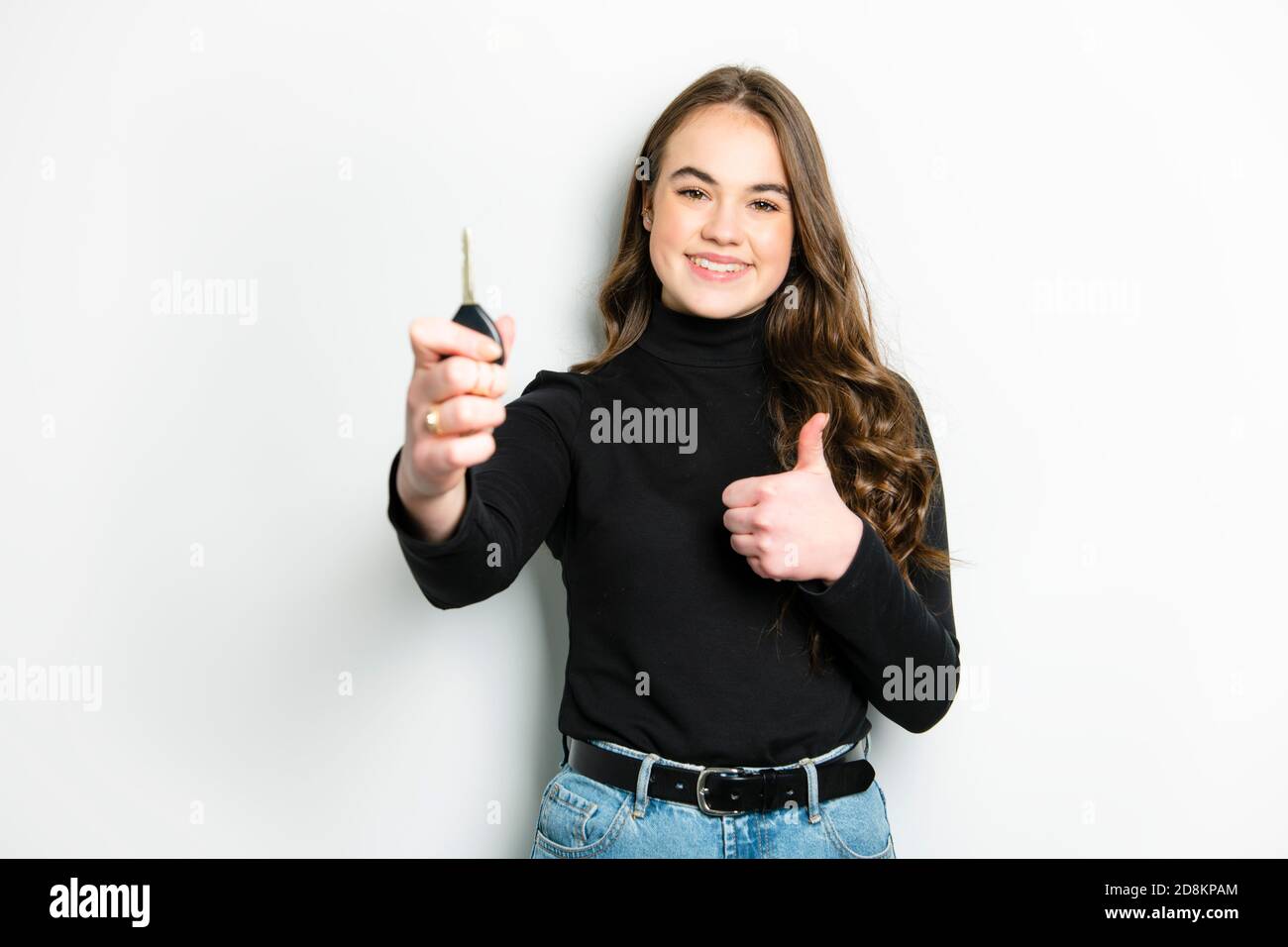 A Teen girl holding key new driver proud Stock Photo - Alamy