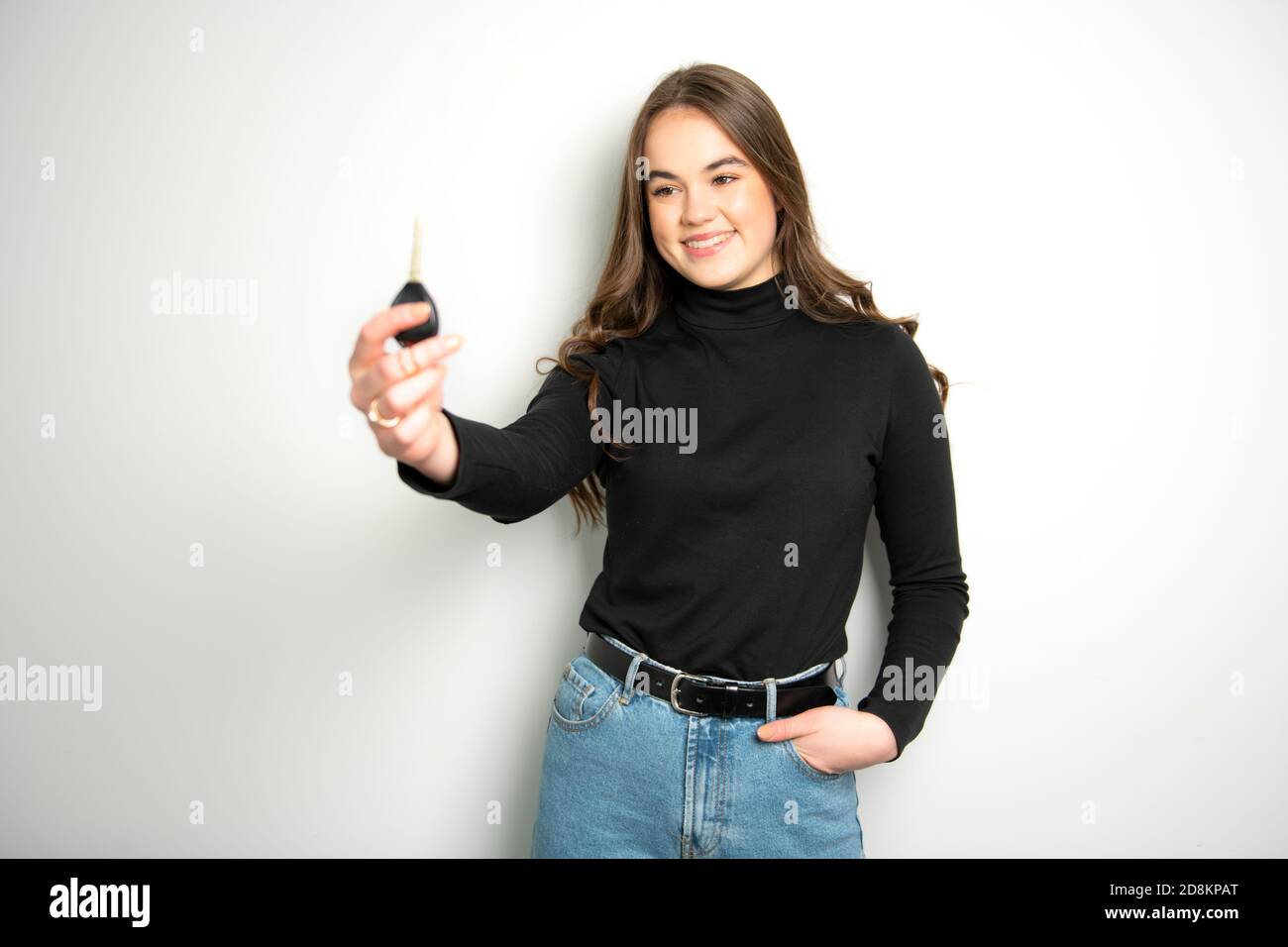 A Teen girl holding key new driver proud Stock Photo - Alamy