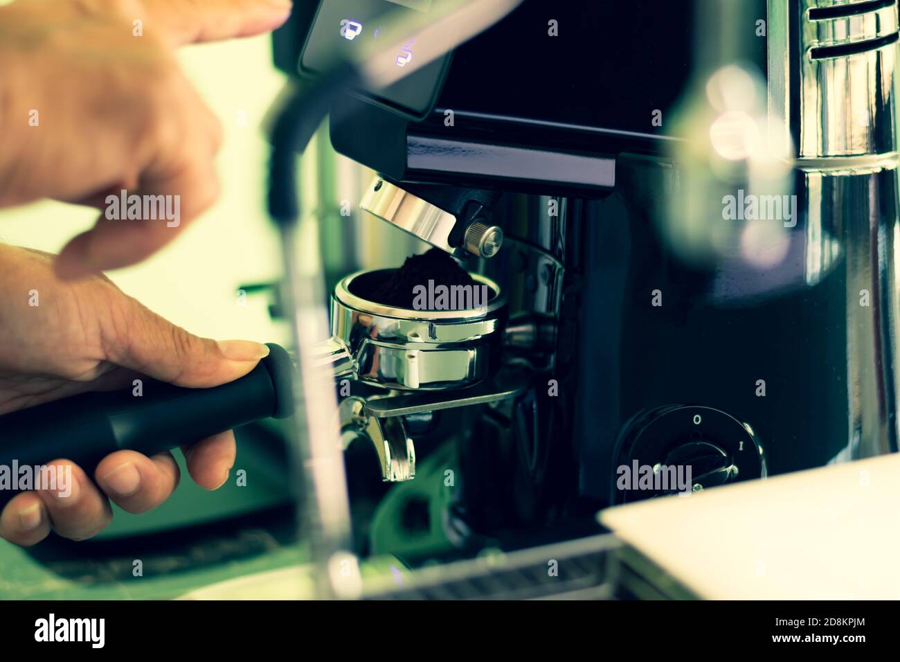 Barista hand grinding fresh roasted specialty coffee in to professional ...