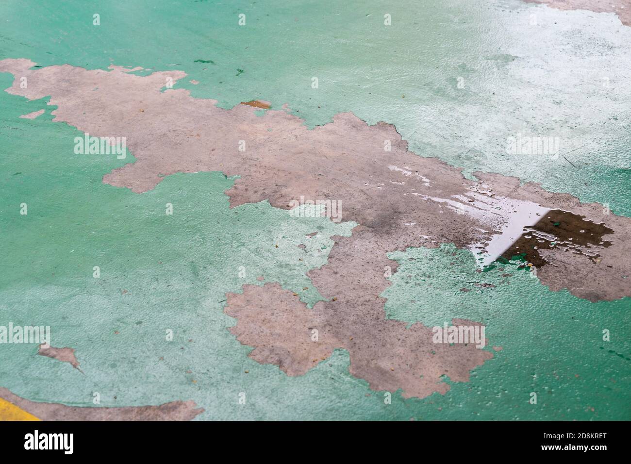 Peeling damaged epoxy layered flooring of workshop in garage Stock ...