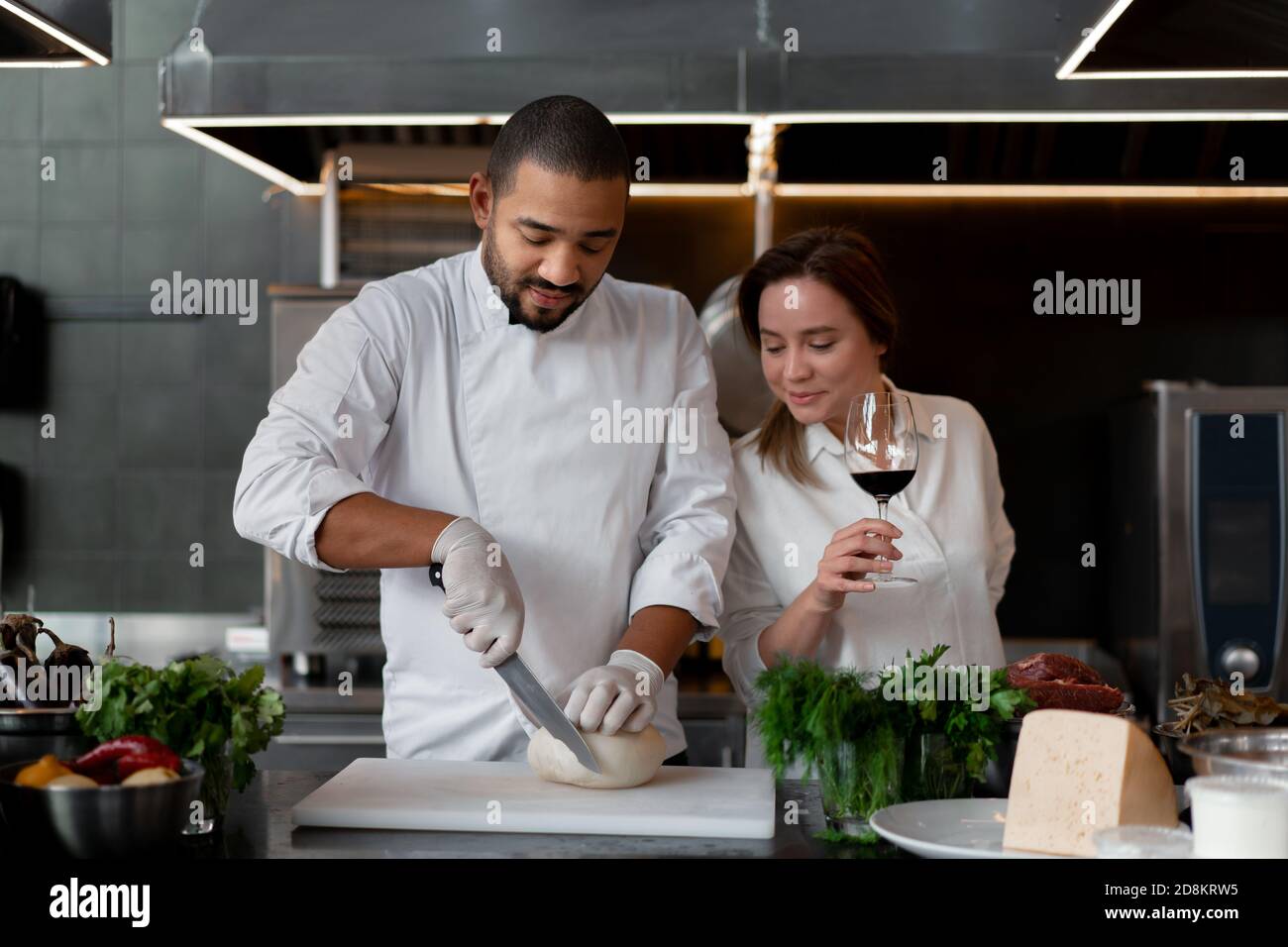 Handsome young African chef is cooking together with Caucasian ...