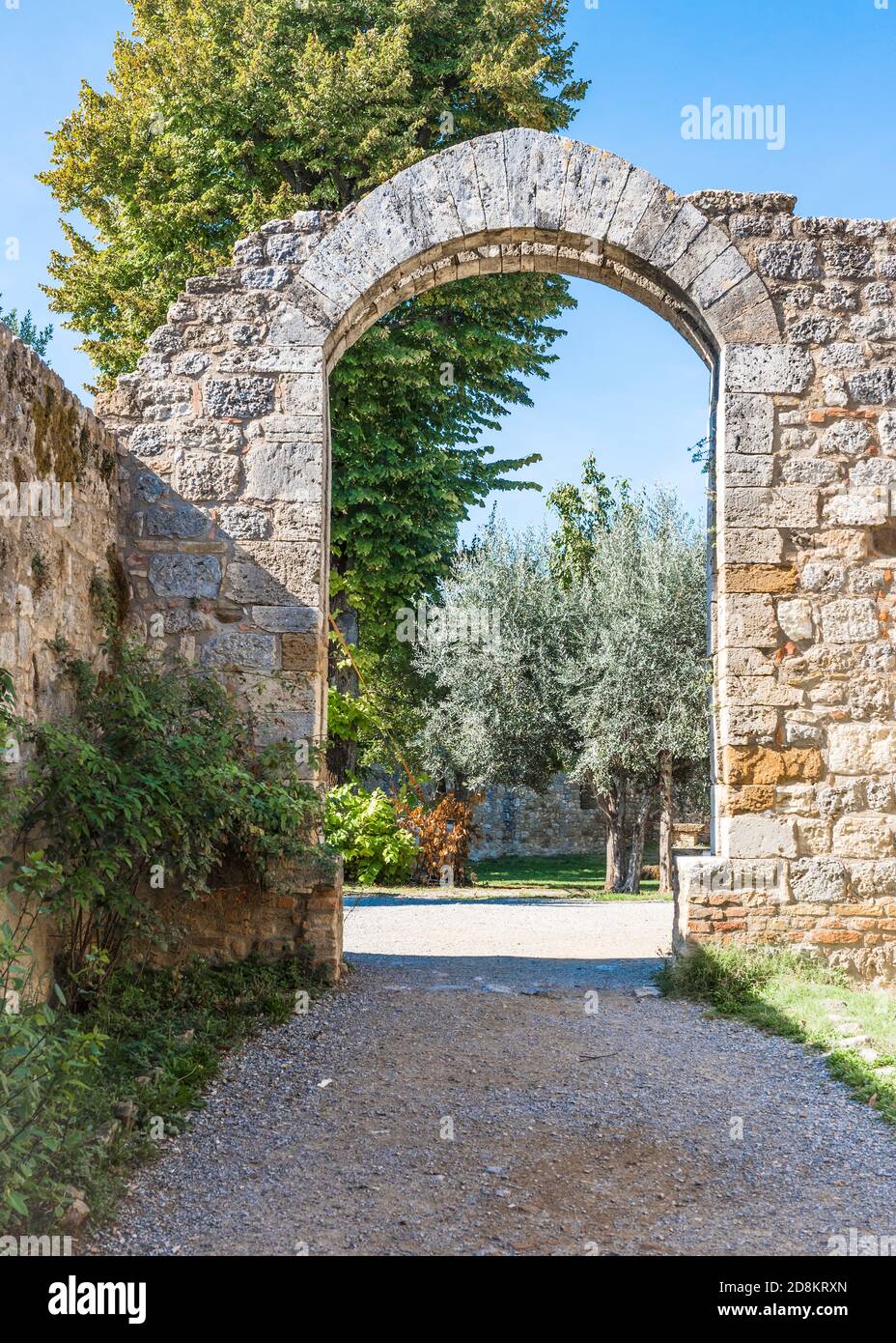 Old stone arch over the alley in the park in the Tuscan city of San ...