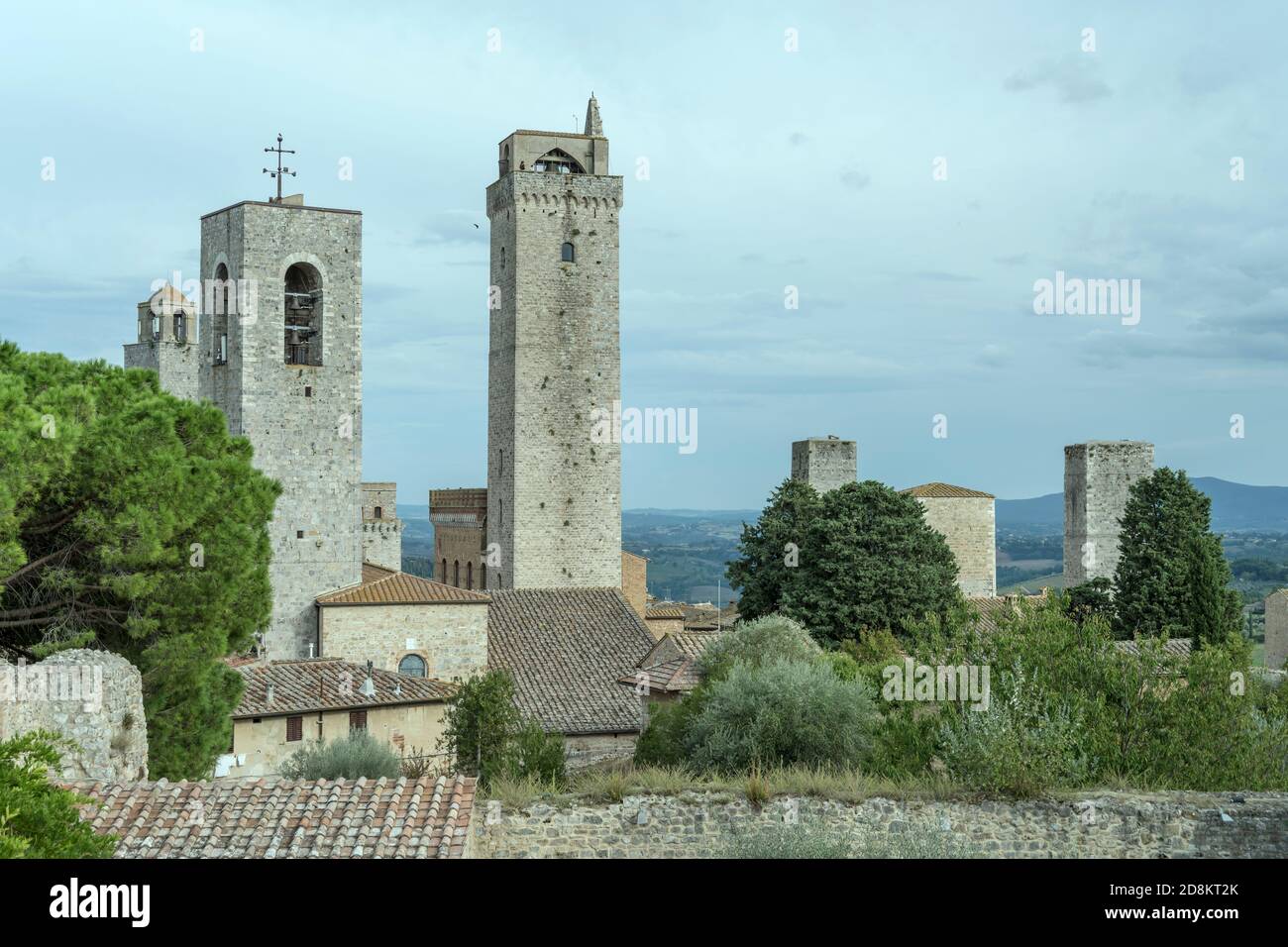 cityscape with high towers looming out of gardens at hilltop historical ...