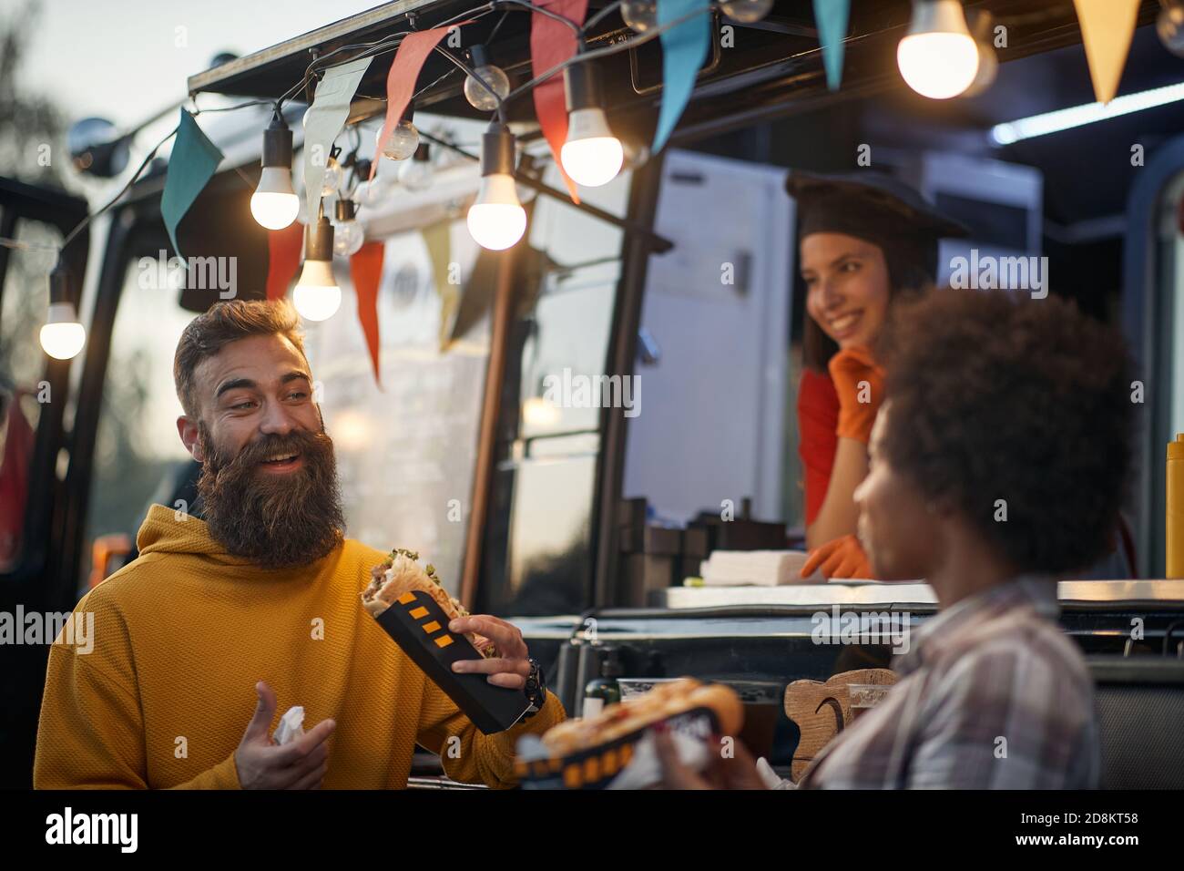 employee at fast food service smiling, looking at satisfied customers ...