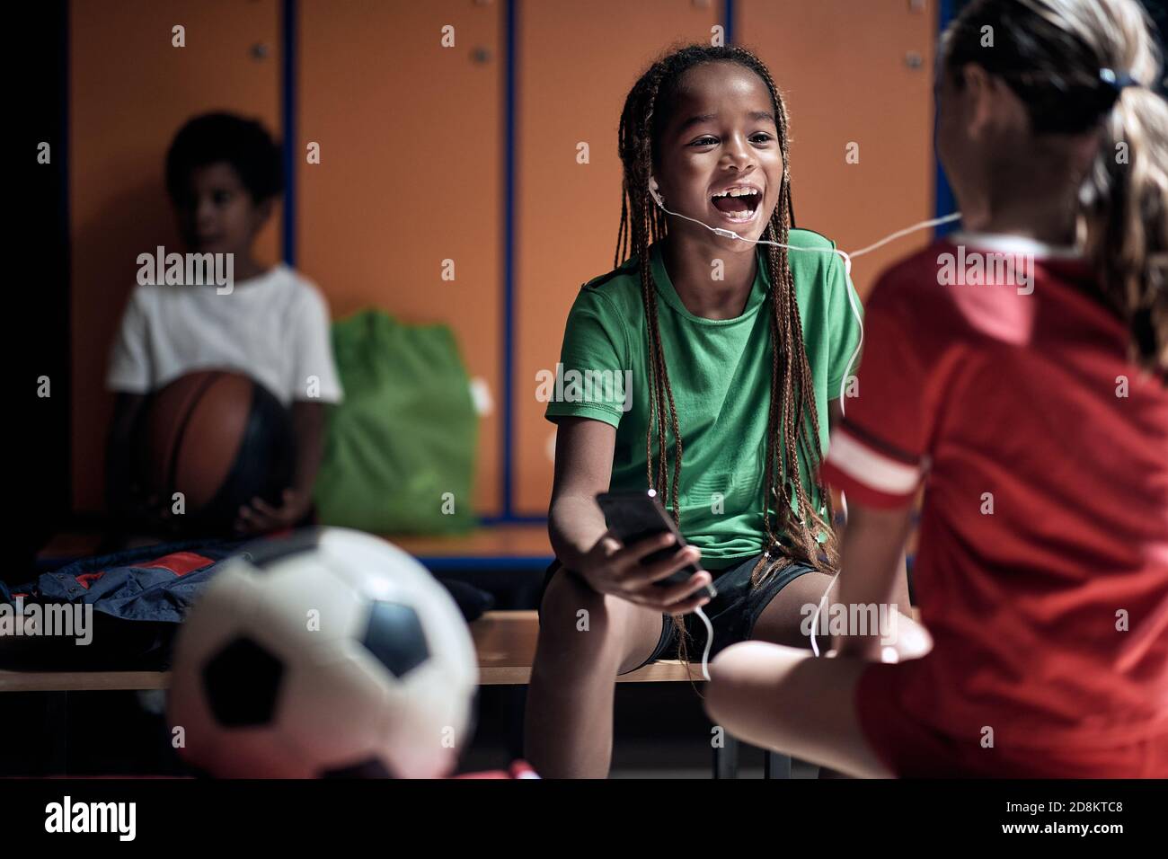 Kids having good time at the locker room before training. Children team ...