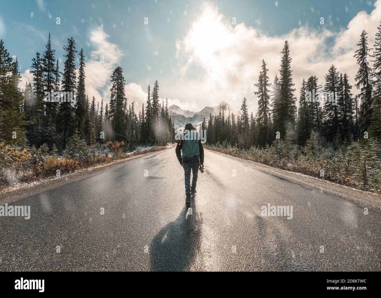 Man backpacker walking with snowing in Banff national park at sunset ...