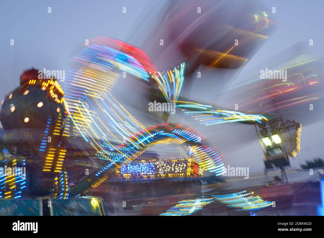 Amusement park blurred effect. Abstract illuminated background Spinning ...