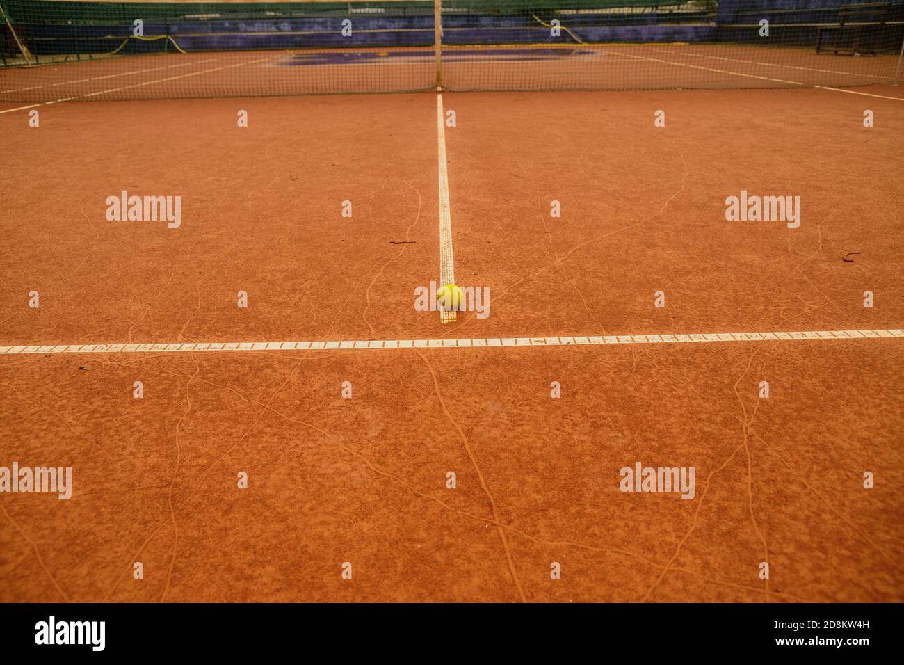 Small tennis ball in the court with a net in the background Stock Photo ...