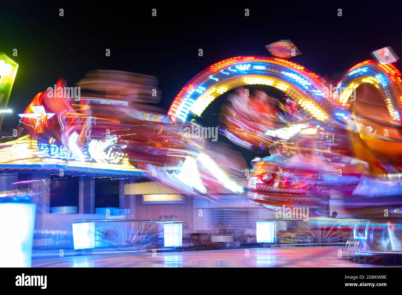 Amusement park blurred effect. Abstract illuminated background Spinning ...