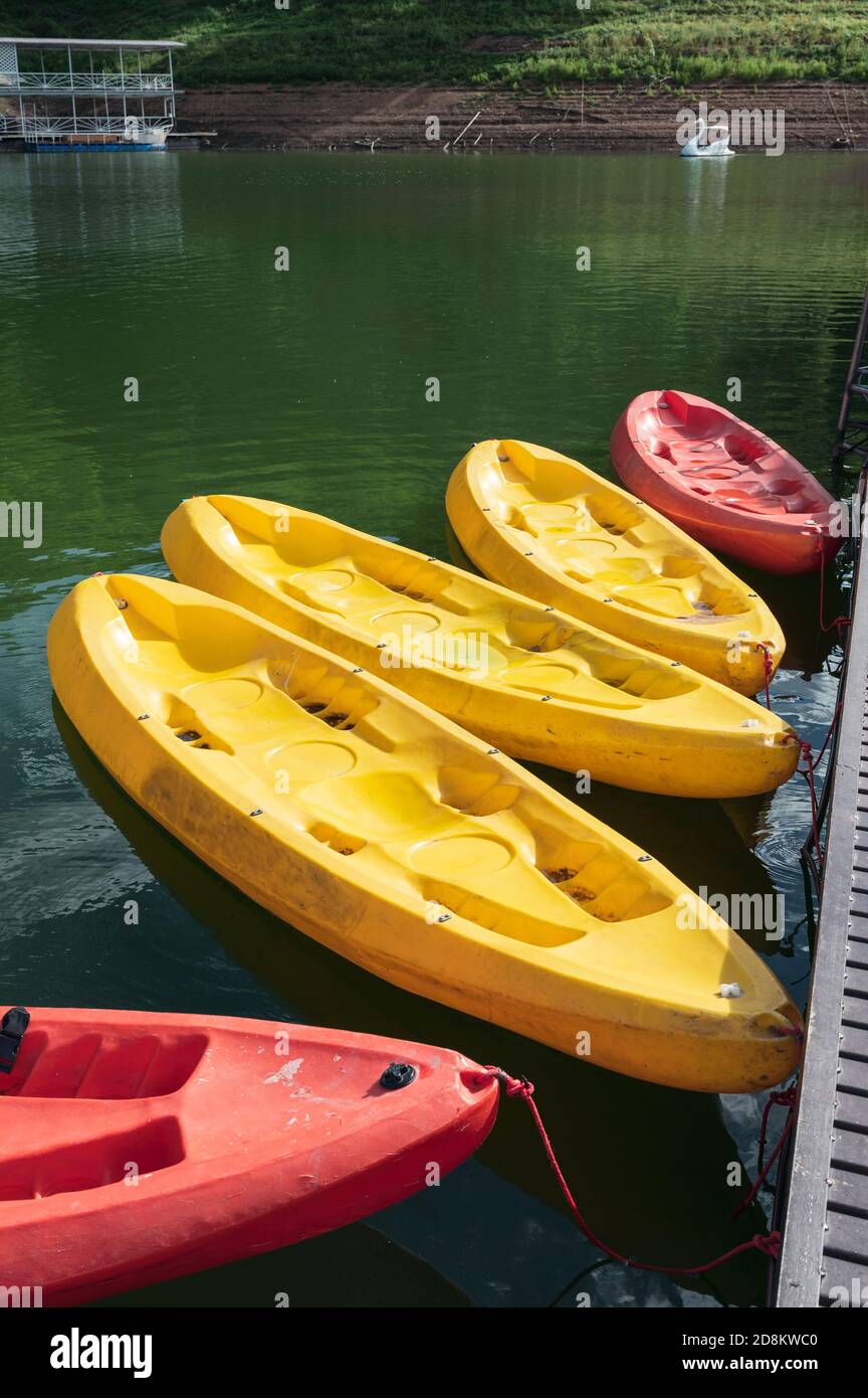 Colorful canoe anchored at wooden pier in lake Stock Photo - Alamy