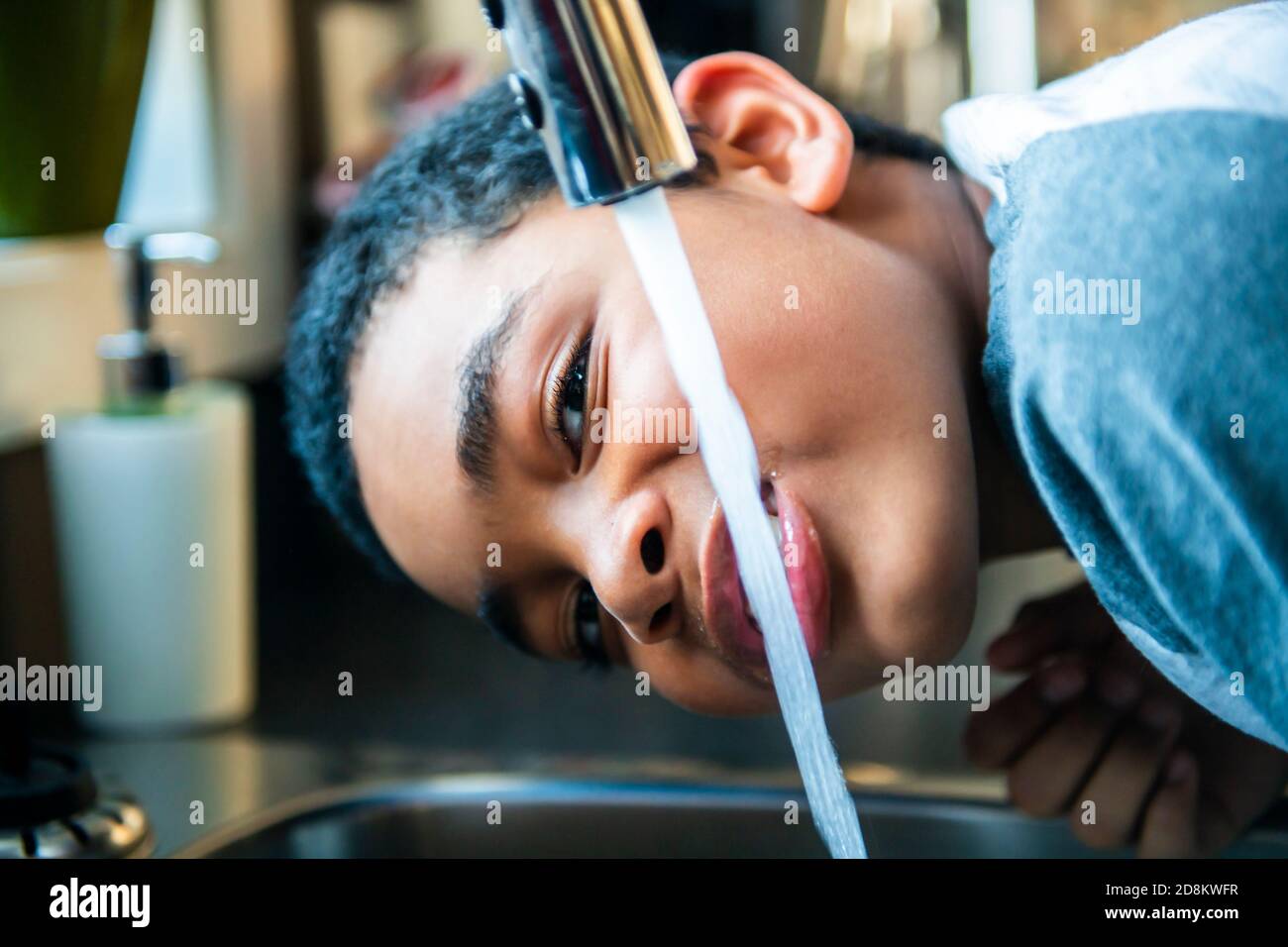 Child washing face sink hi-res stock photography and images - Alamy
