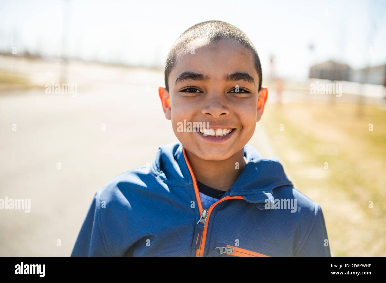 The Children Smiling outside in spring season with coat Stock Photo - Alamy