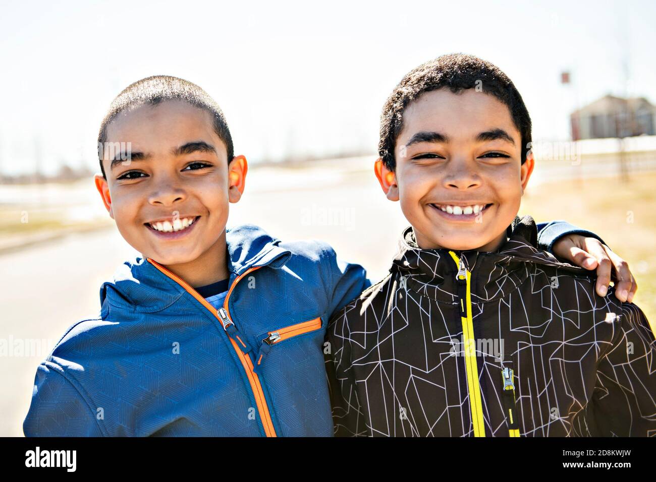 The Children Smiling outside in spring season with coat Stock Photo - Alamy