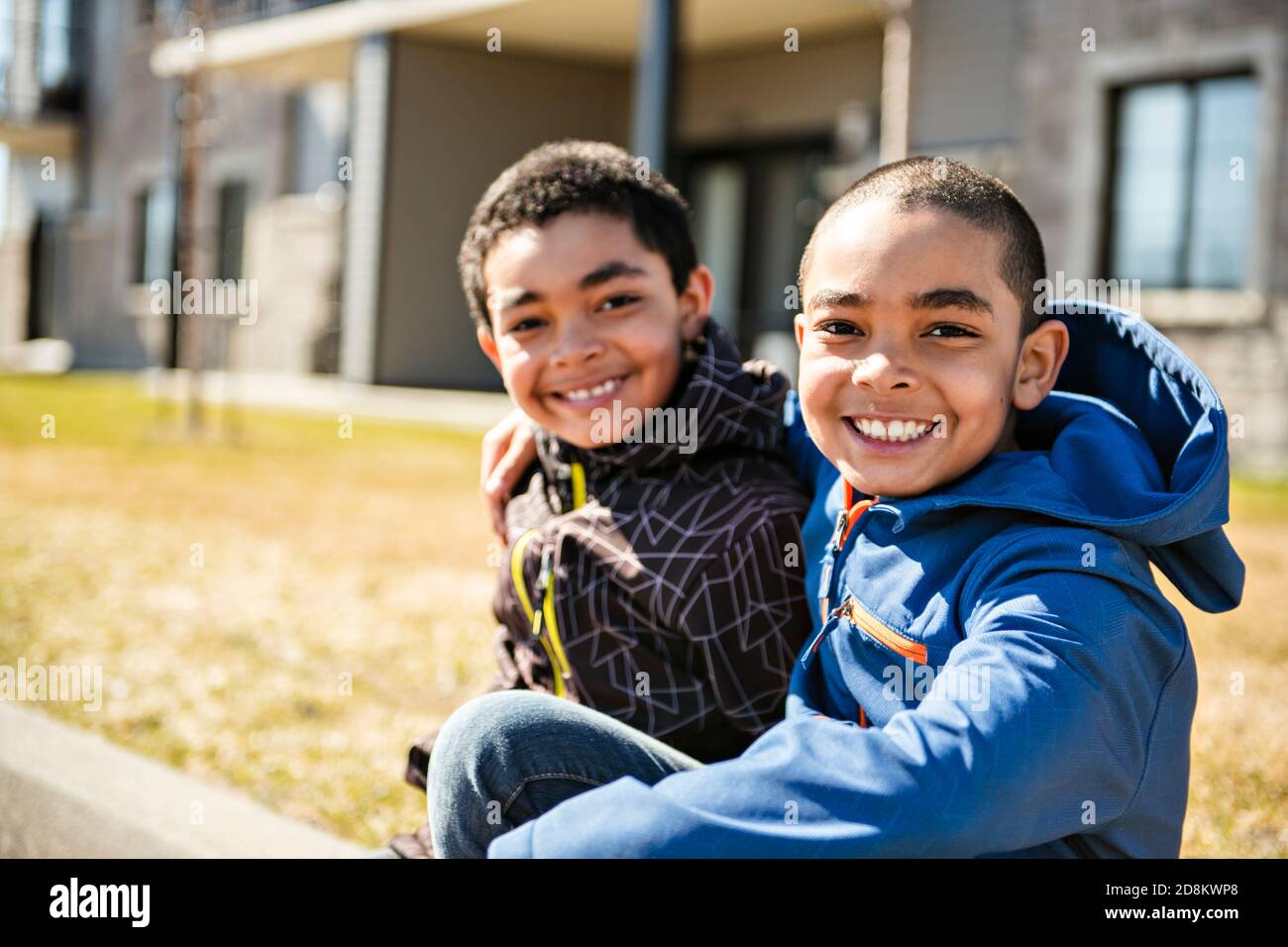 The Children Smiling outside in spring season with coat Stock Photo - Alamy